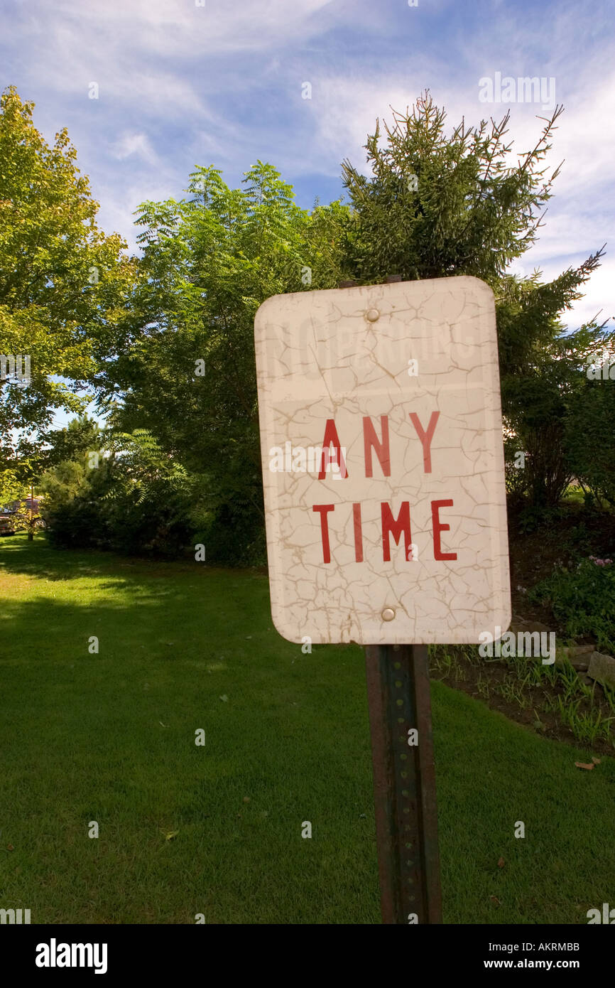 No Parking Any TIme sign with no parking hidden blue skies and trees ...