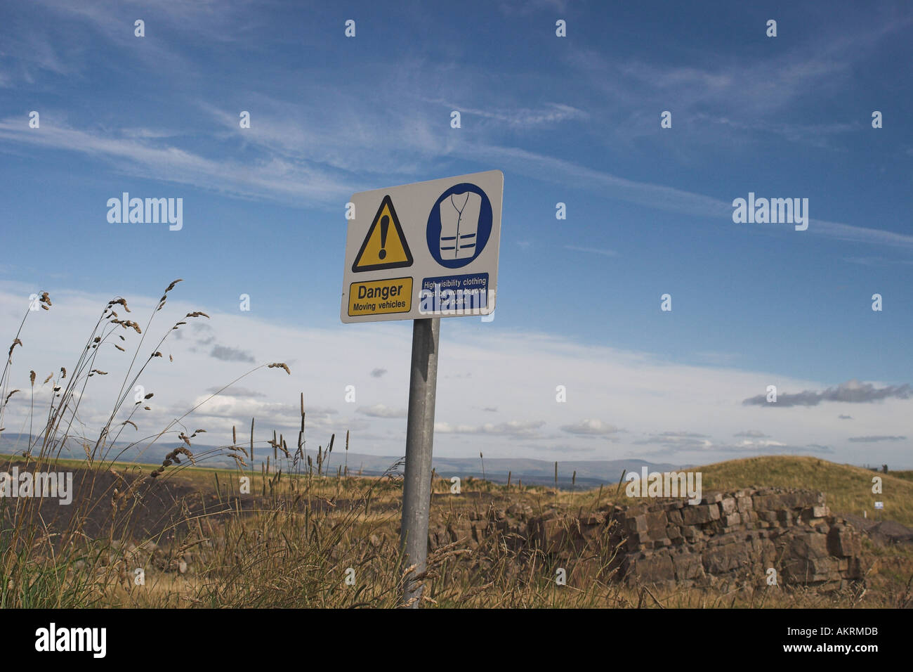 warning sign in quarry to say wear protective equipment because of ...