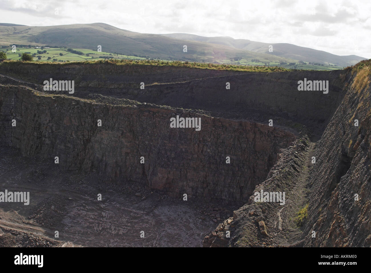 levels and layers of rock in a disused quarry in the lake district ...