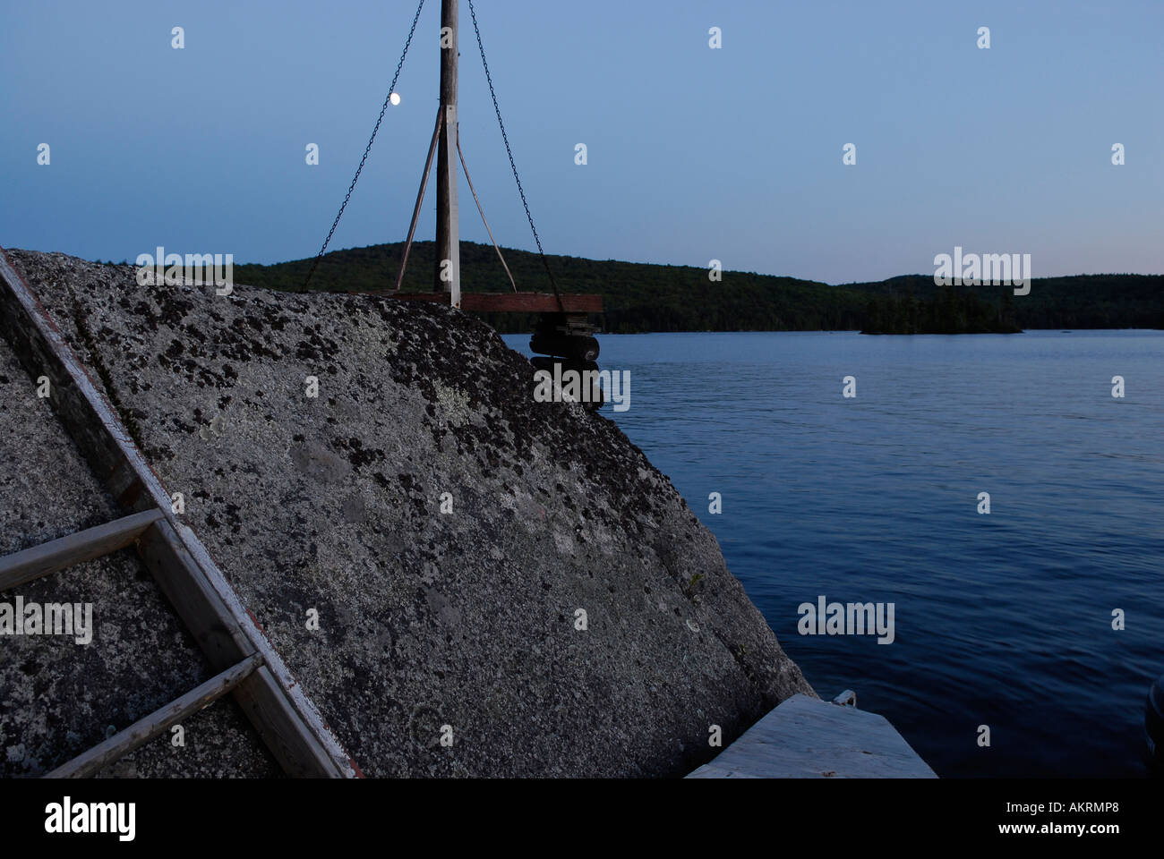 Stock image of huge stone and dock at night under a full moon at skiff ...