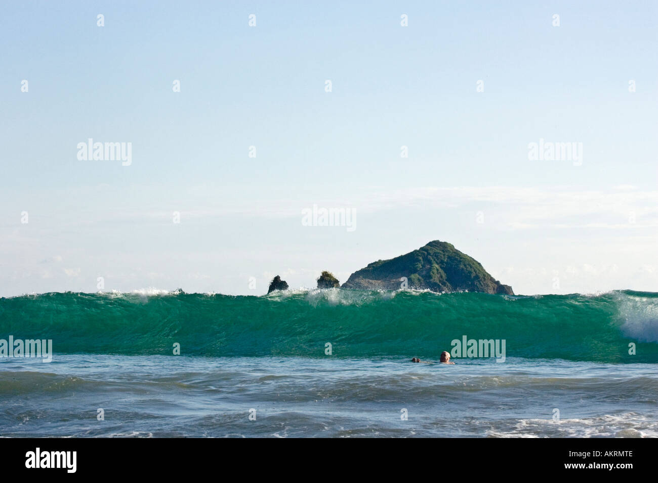 Wave approaches swimmer at Manuel Antonio National Park beach, Costa ...