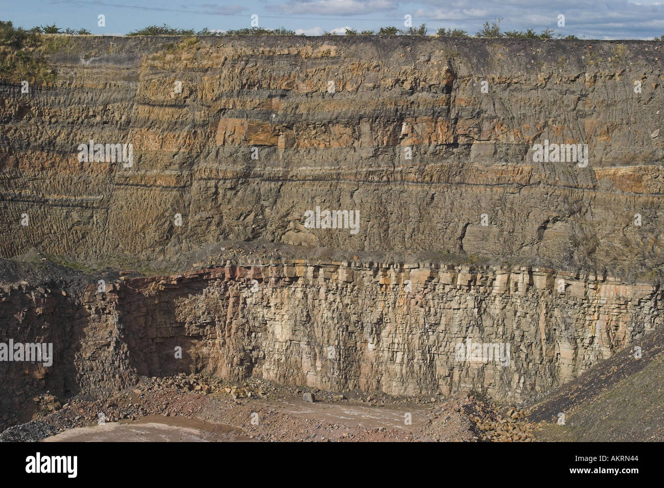 levels and layers of rock in a disused quarry in the lake district ...