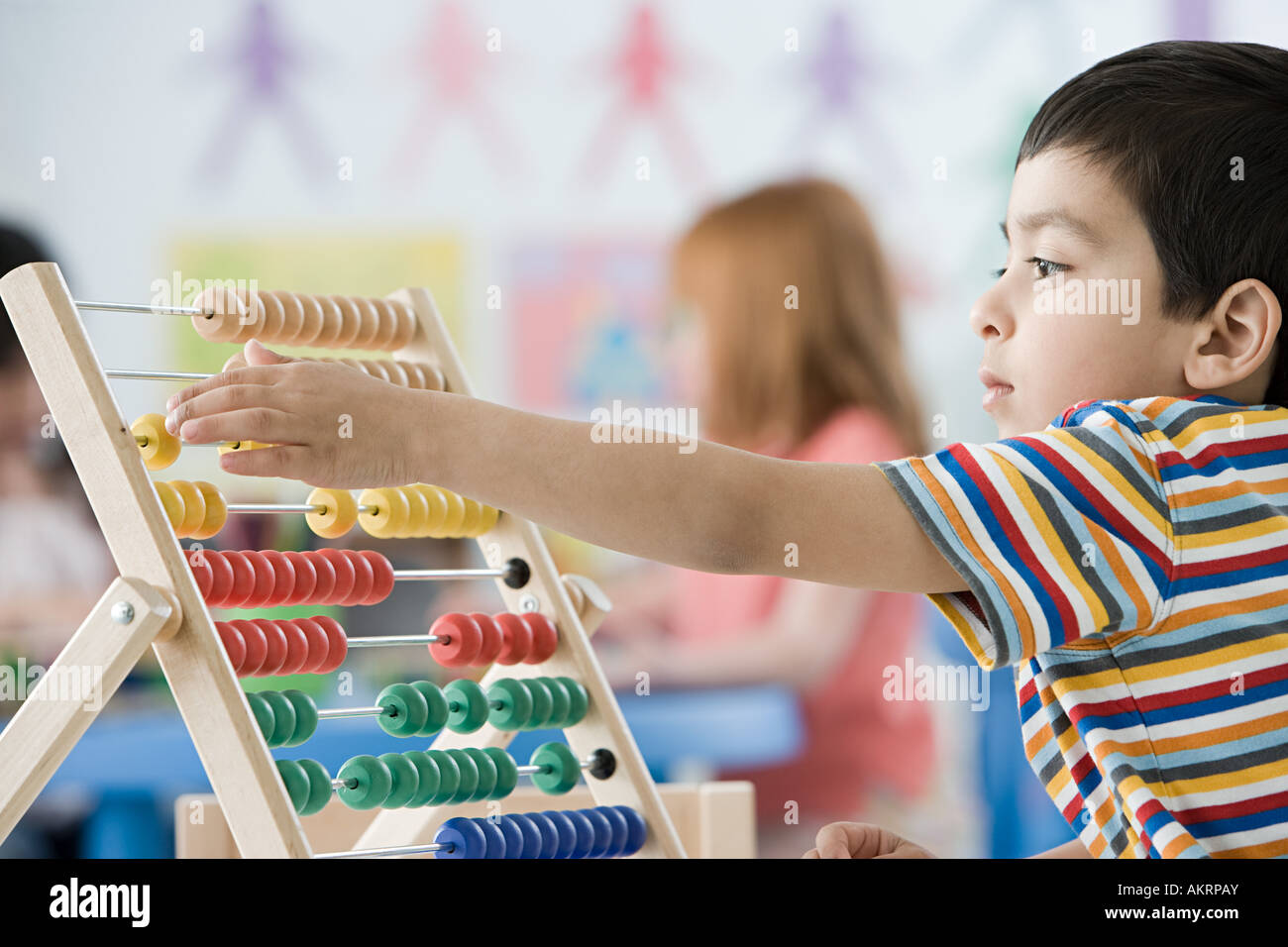 A boy counting on abacus Stock Photo - Alamy