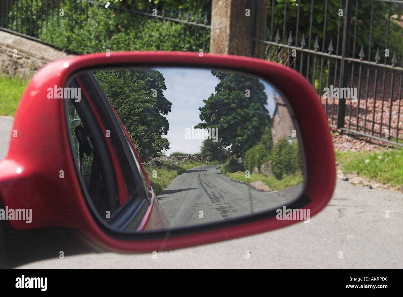 the mirror of a car looking back into the countryside Stock Photo - Alamy