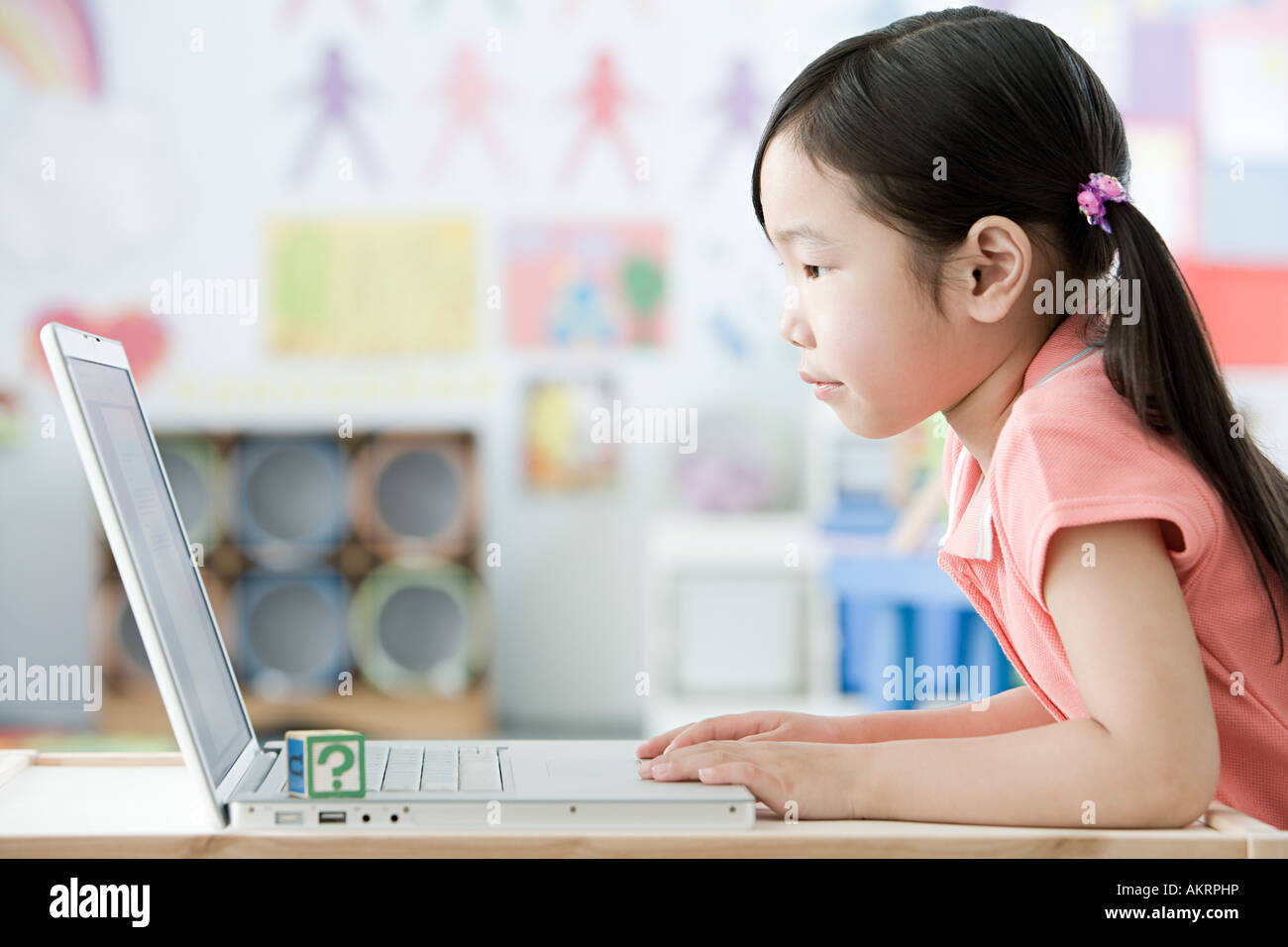 A girl using a laptop Stock Photo - Alamy