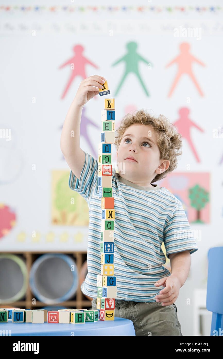 Boy playing with building blocks Stock Photo - Alamy