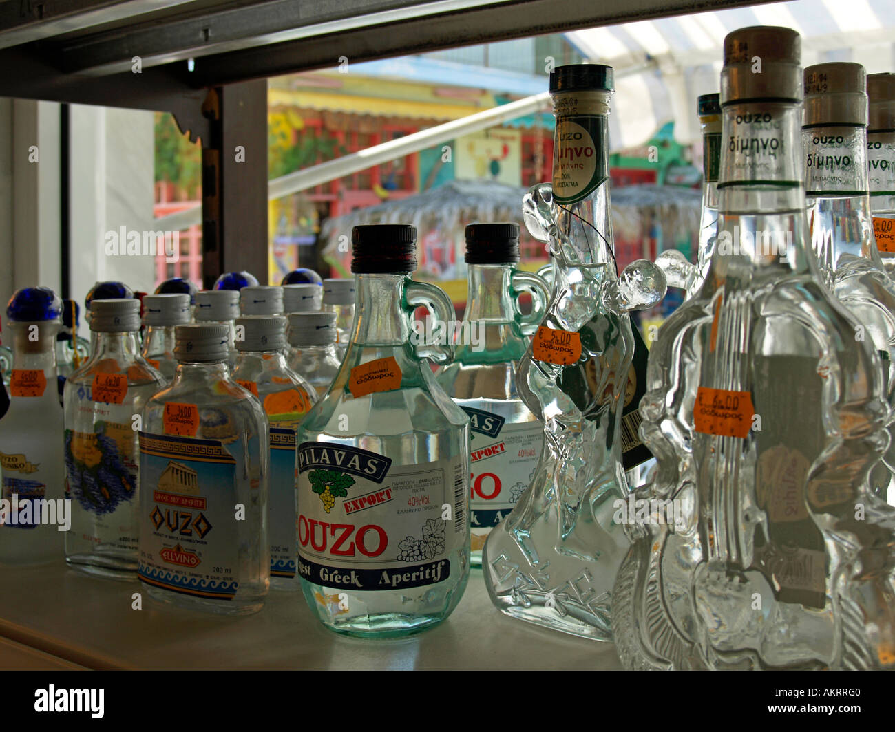 bottles with Ouzo in differen forms and sizes for sale in a display ...