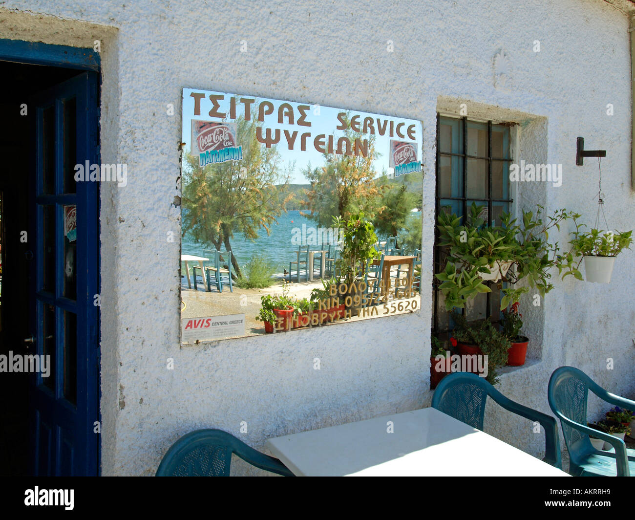 greek kafenion bar restaurant with a mirror on the wall reflecting the ...