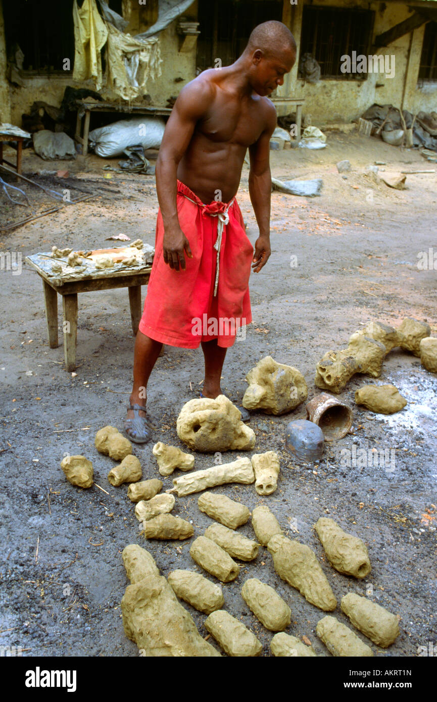 A metal smith looks over expendable mold casts Stock Photo - Alamy