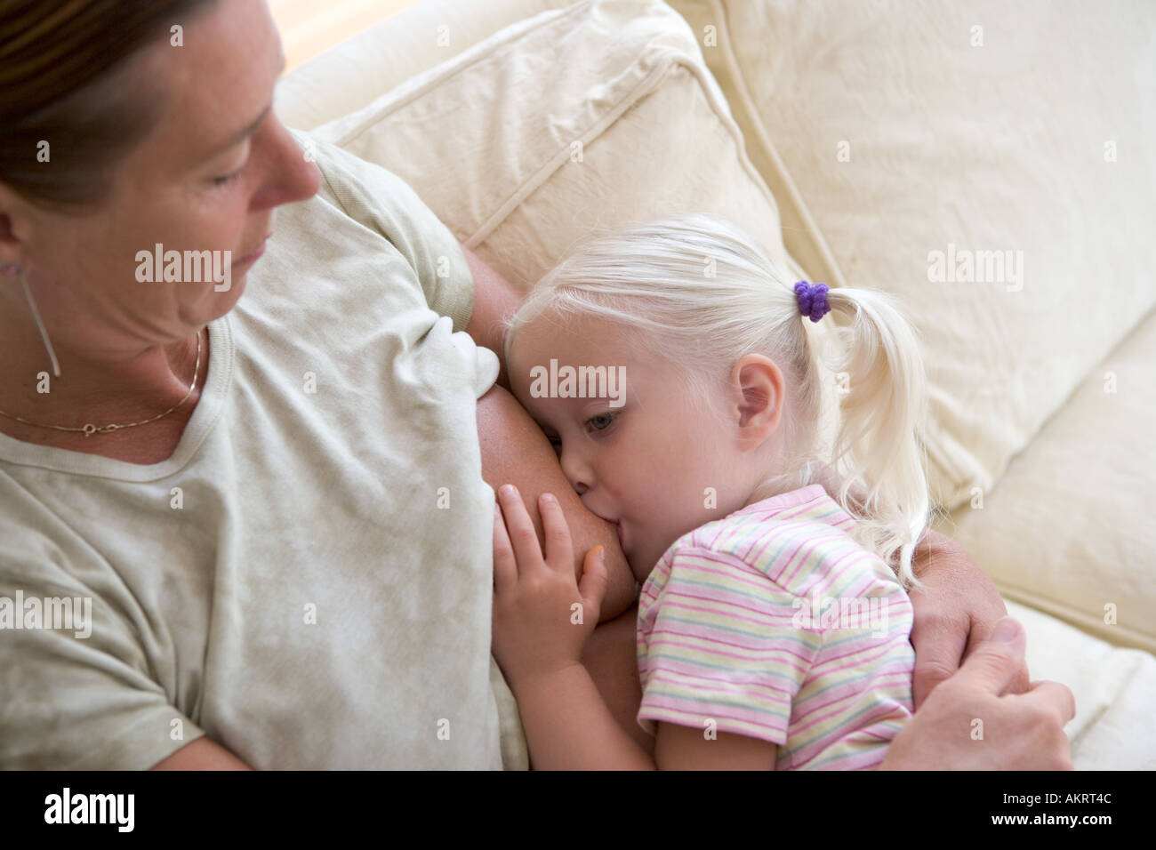 Breastfeeding a 3 year old girl Stock Photo - Alamy
