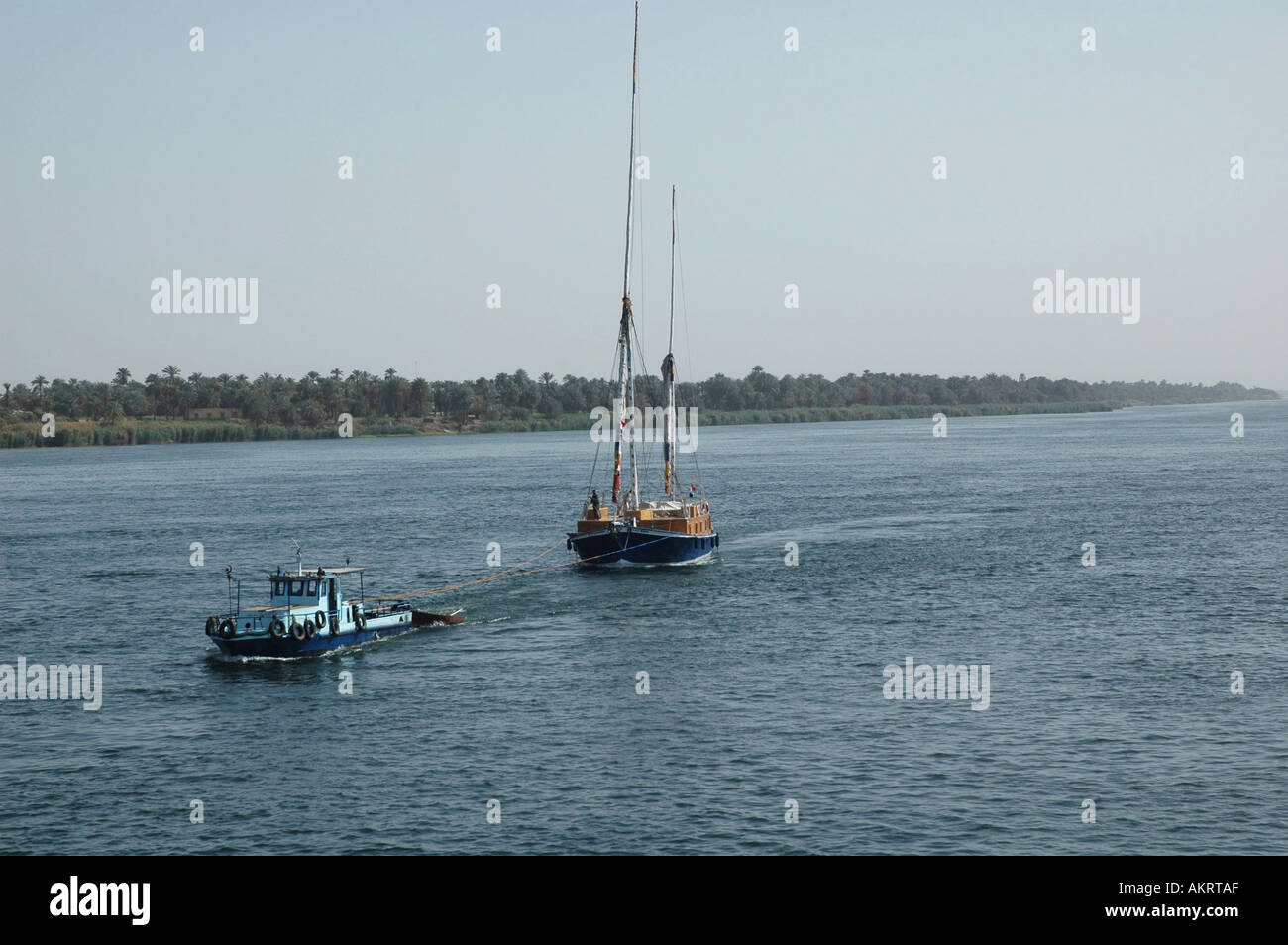 Tug pulling sail boat on the River Nile Egypt Stock Photo - Alamy