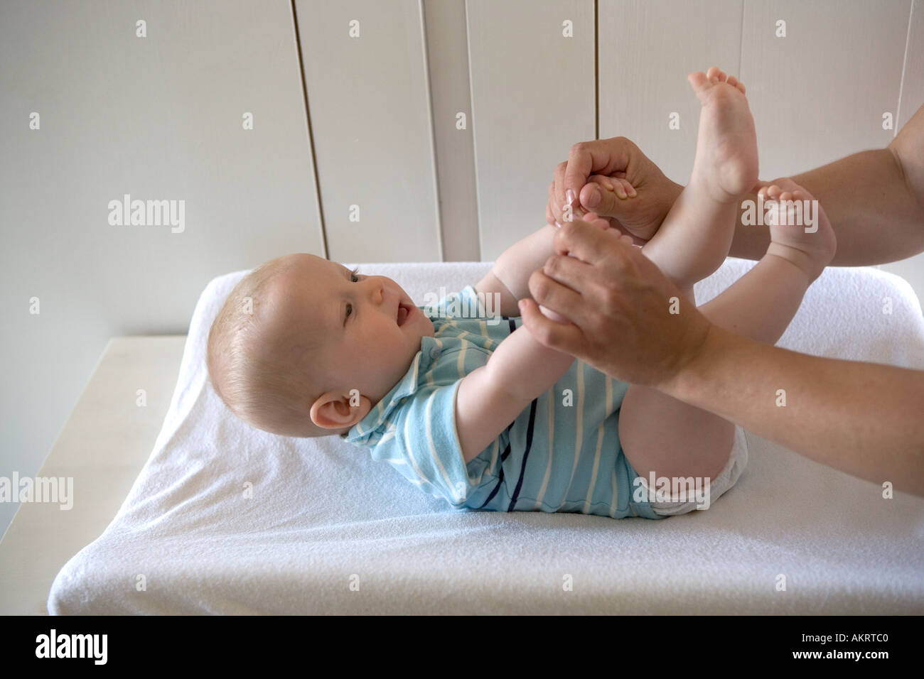 Mother is lifting a baby on his hands Stock Photo - Alamy