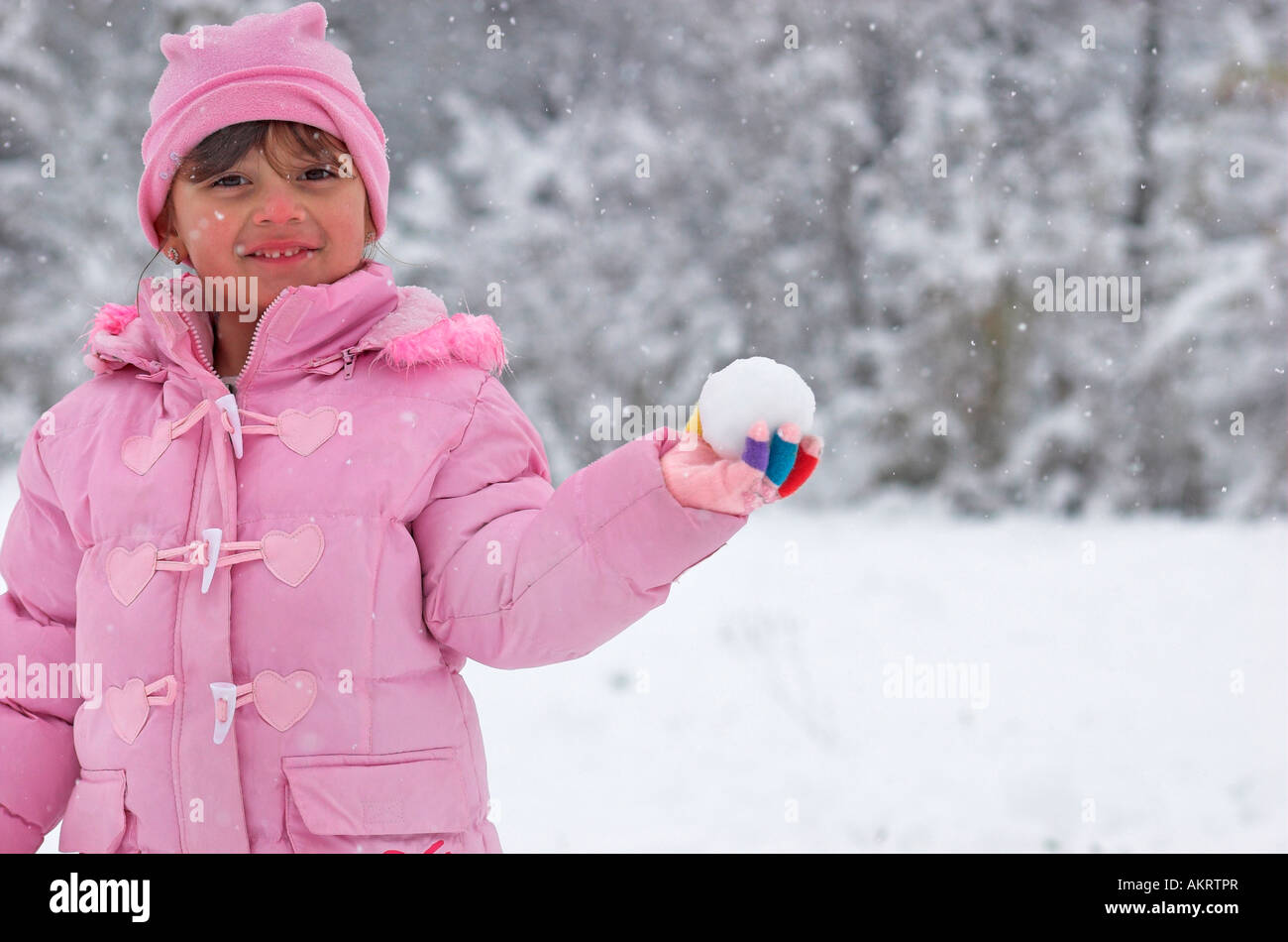 Smiling Girl Holding Snowball Stock Photo - Alamy