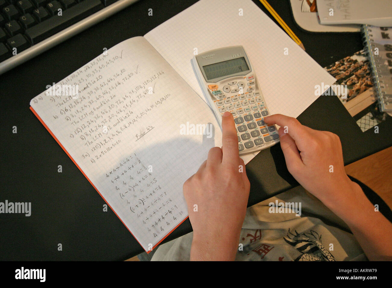 boy using calulator to do maths homework Stock Photo - Alamy