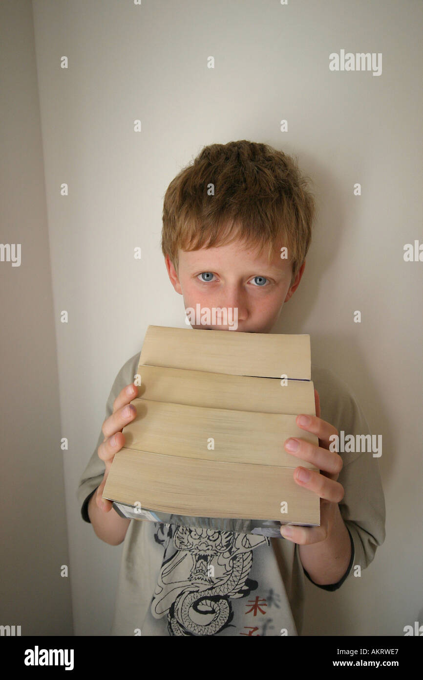 boy holding lots of books Stock Photo - Alamy