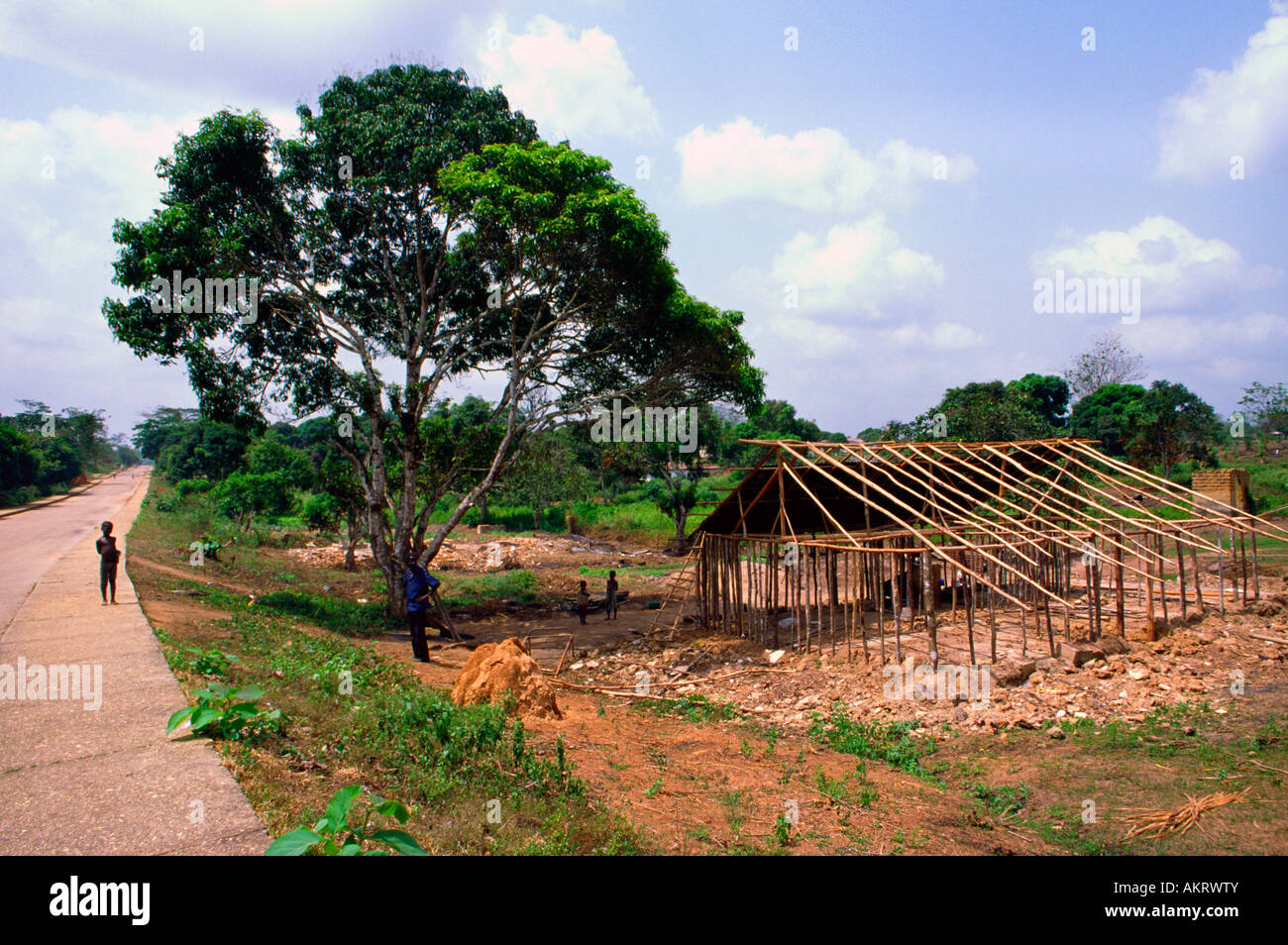 A man rebuilds a house in the aftermath of civil war in Zwedru Liberia ...