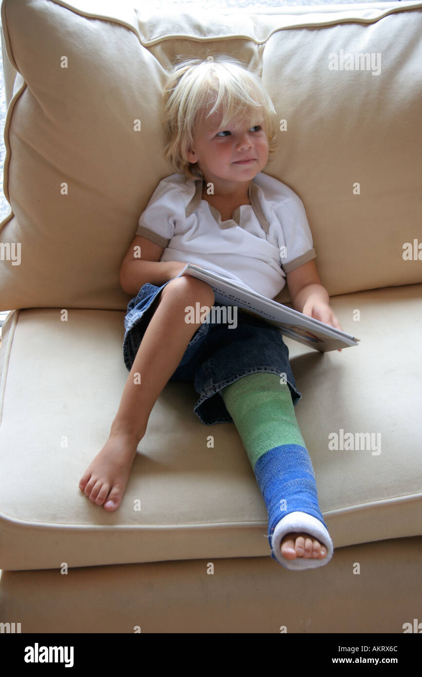 Little boy with a broken leg sitting on a bench Stock Photo - Alamy