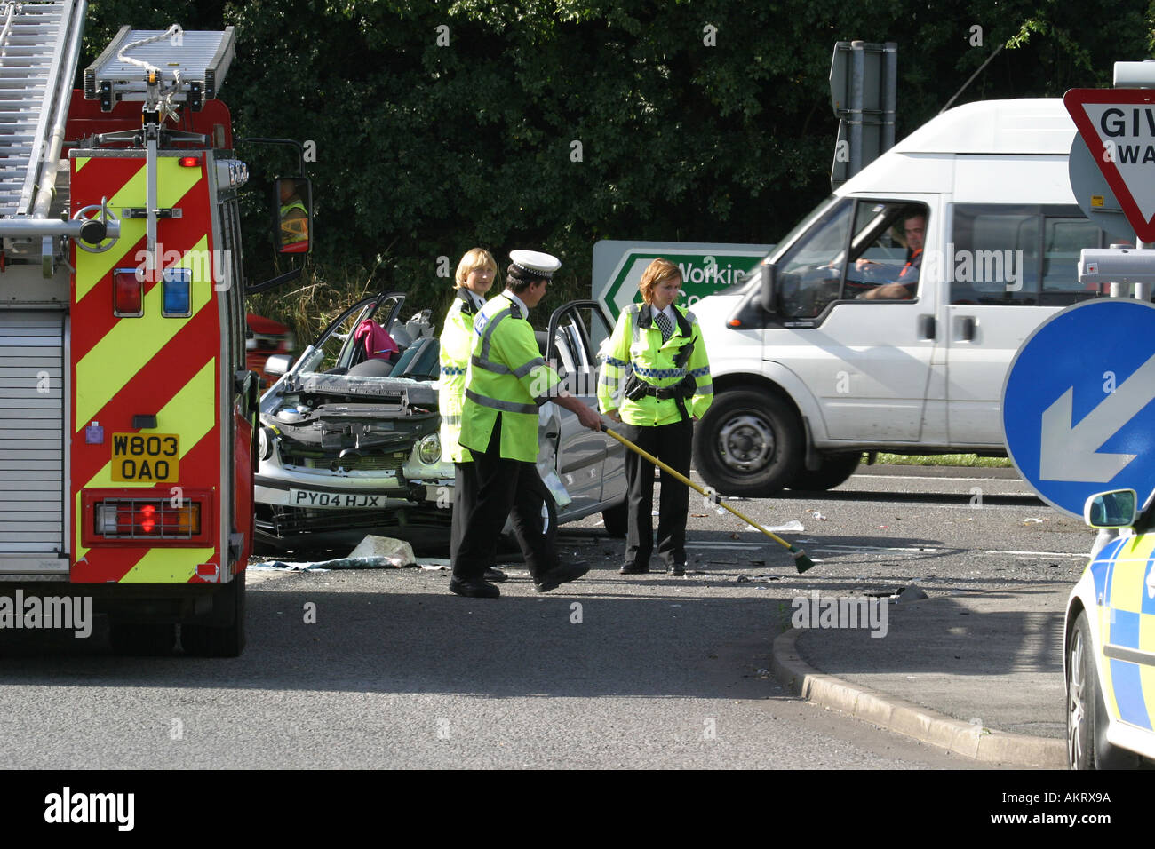Police Officer cleaning up after a road traffic accident Stock Photo ...