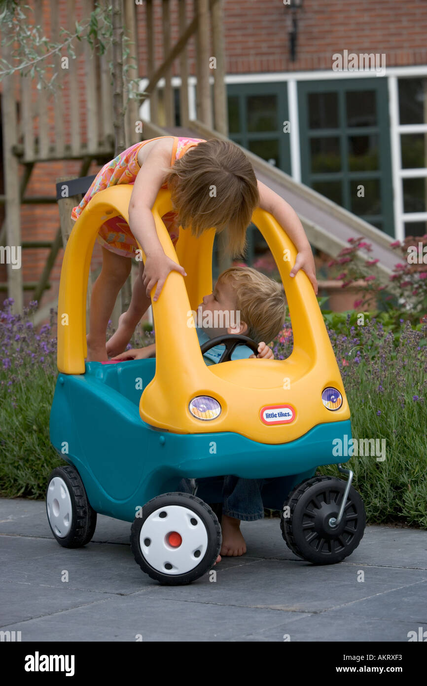 Children playing wit a toy car Stock Photo - Alamy