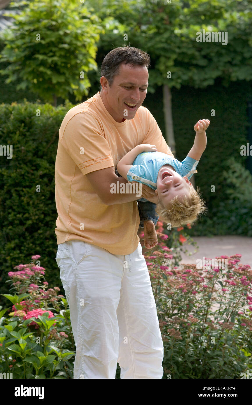 Father and son romping Stock Photo - Alamy