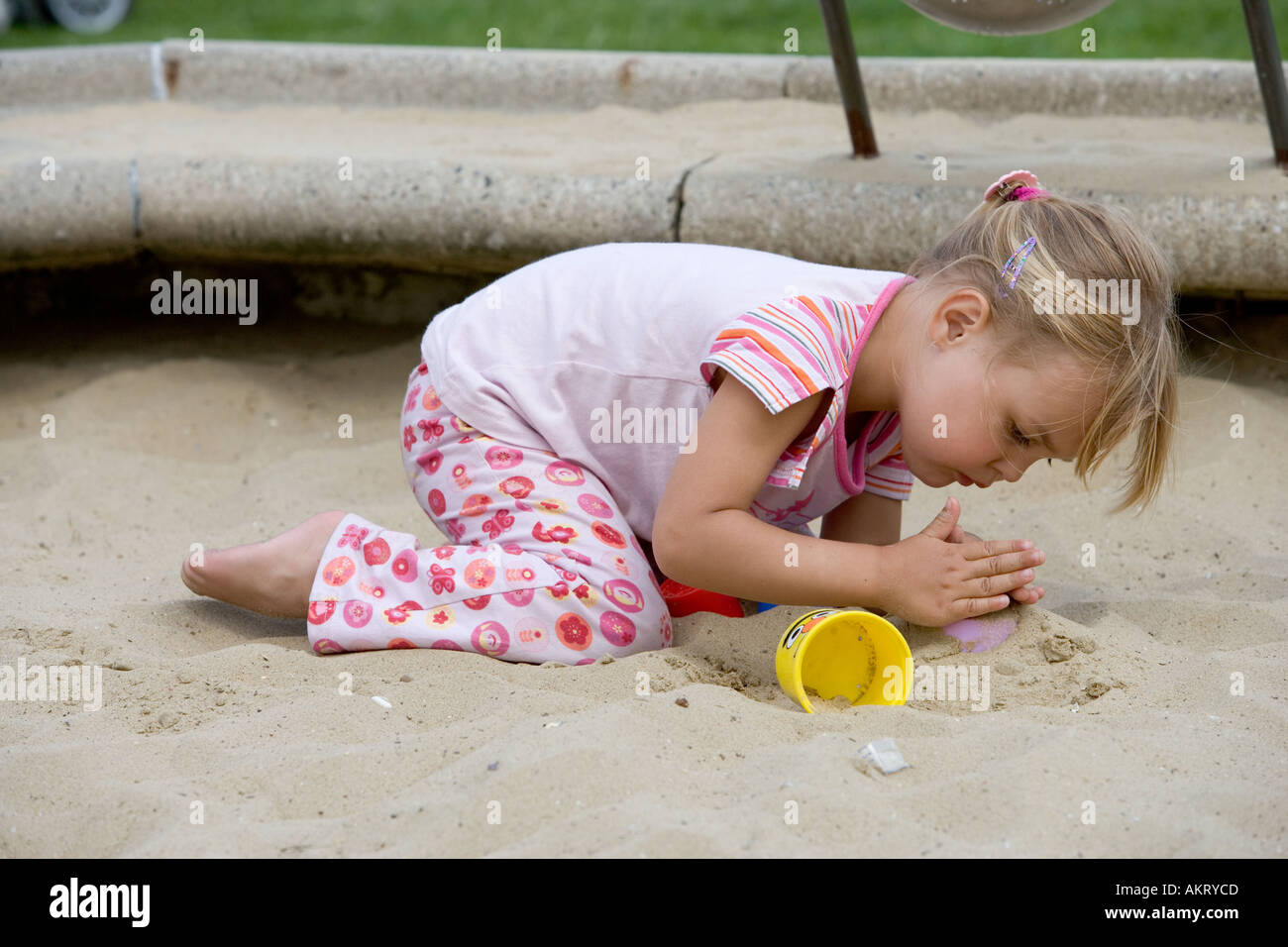 Girl playing in sand pit Stock Photo - Alamy