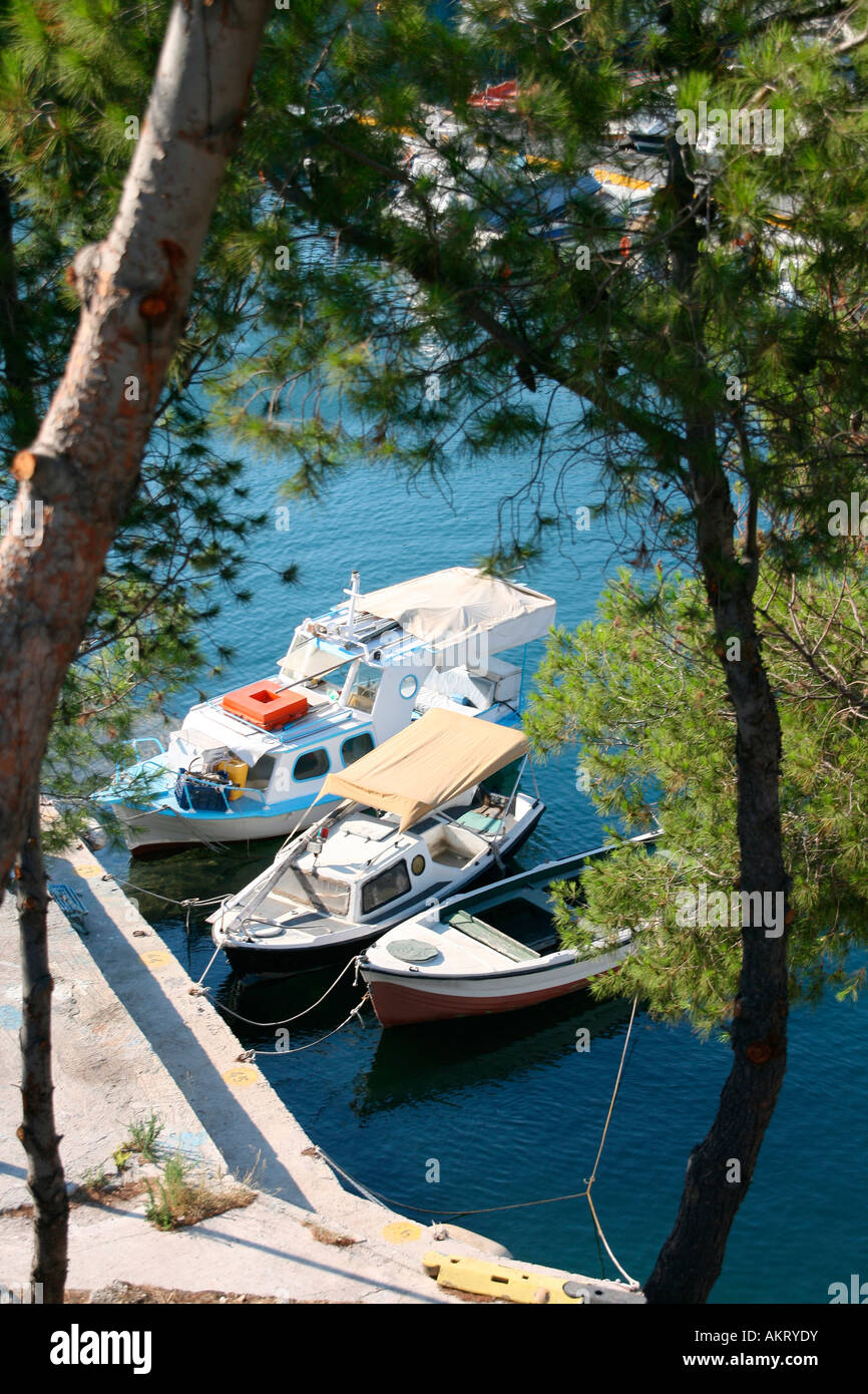 three small fishing boats in marina between trees Stock Photo - Alamy