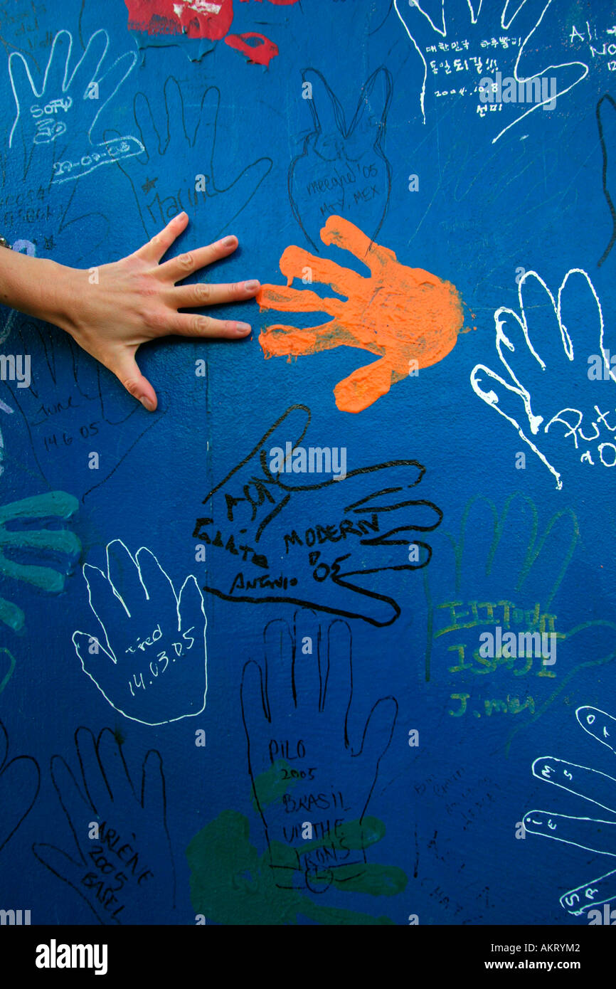 A human hand touching a graffiti hand on the Berlin wall, Berlin Stock ...