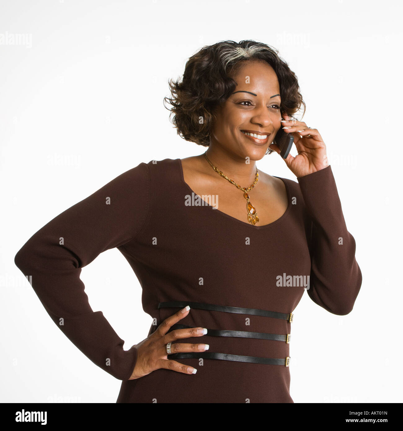 Portrait of woman holding telephone to ear and smiling Stock Photo - Alamy