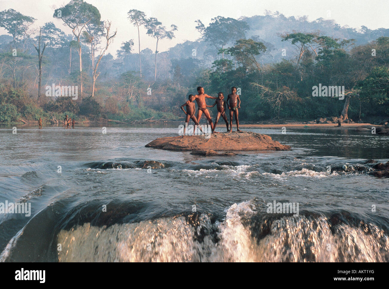Four 4 young black African Pygmy boys playing in a river in Zaire ...