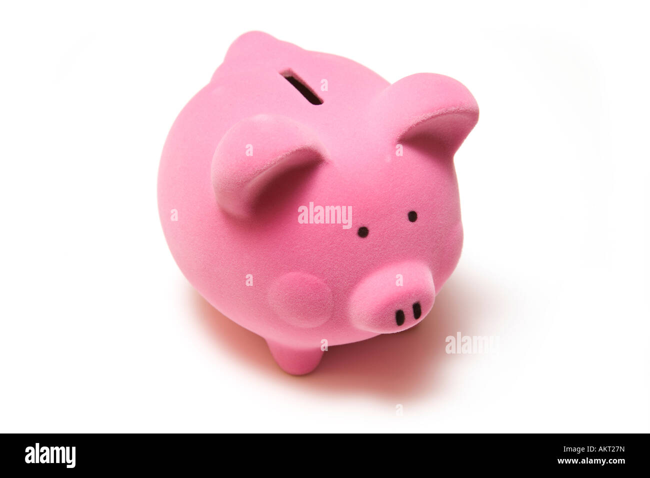Pink piggy bank style money box isolated on a white studio background ...
