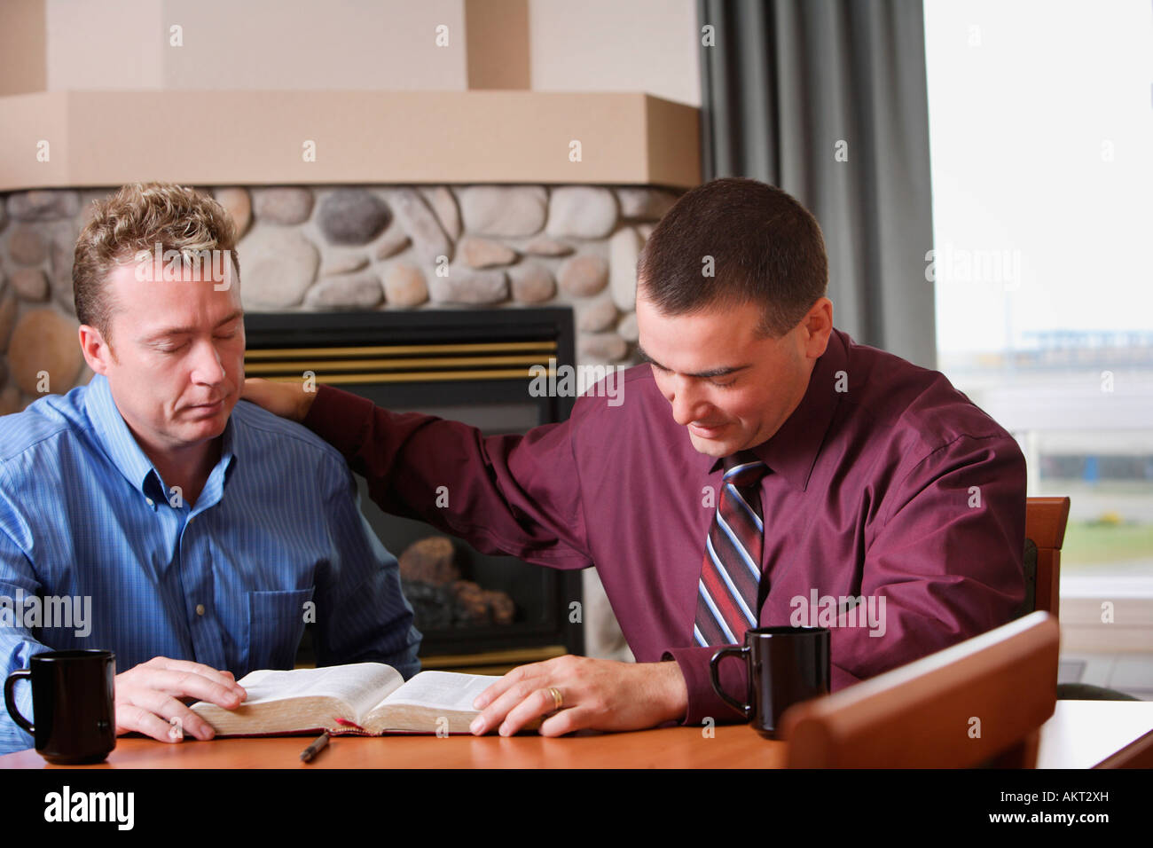 Two men praying Stock Photo - Alamy