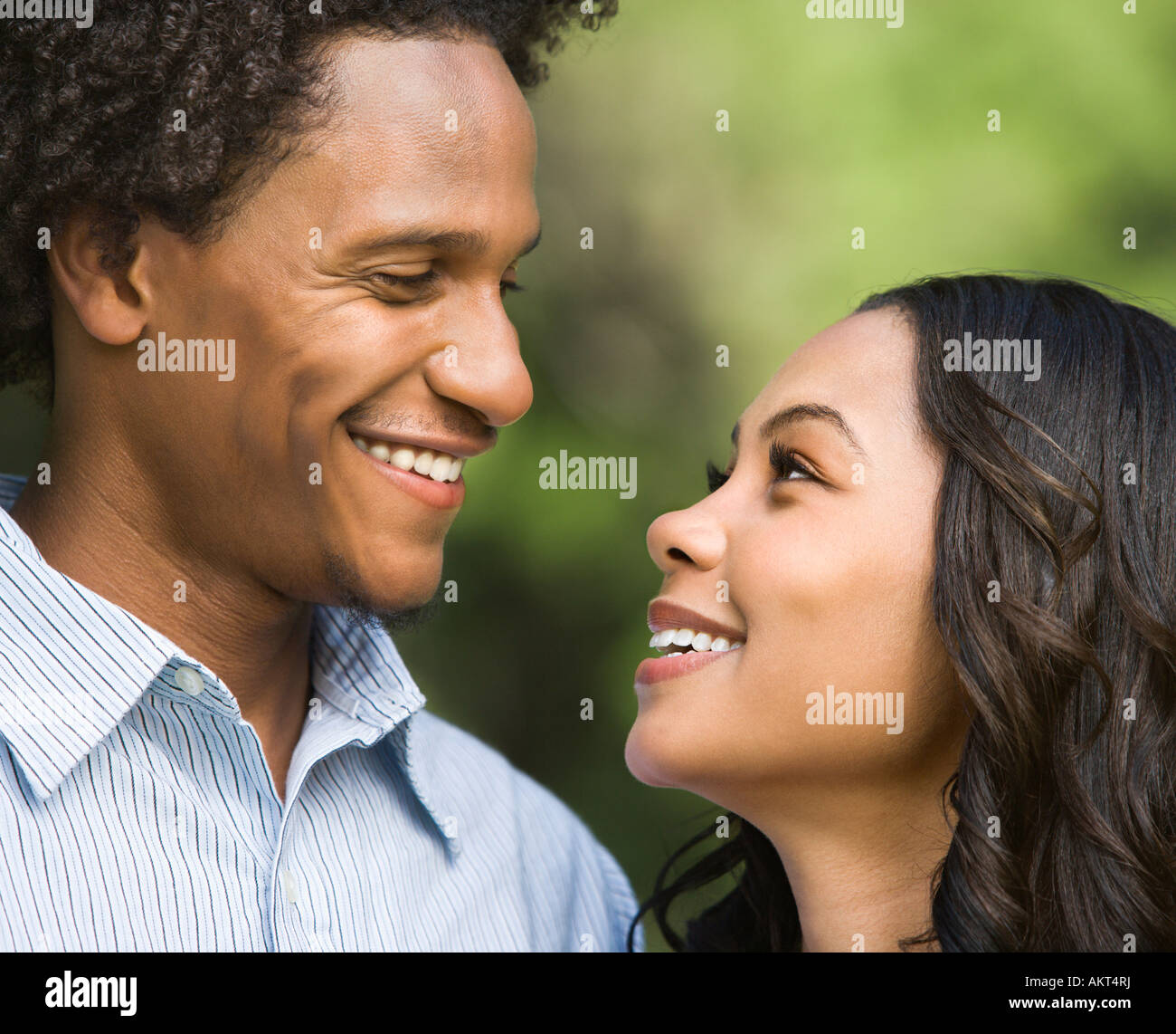 Portrait of smiling couple looking into eachother s eyes Stock Photo ...