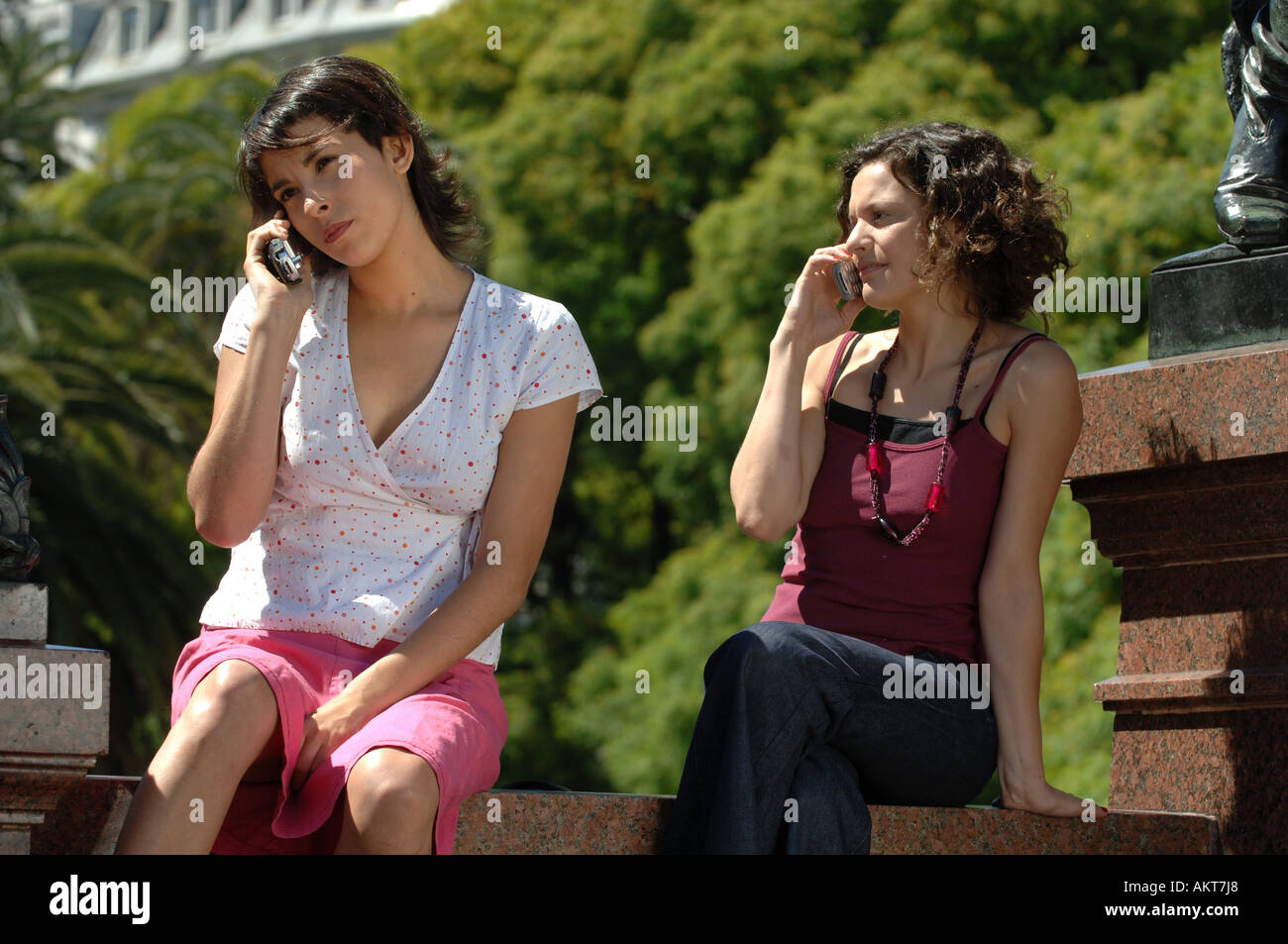 Two women with cellphones Stock Photo - Alamy