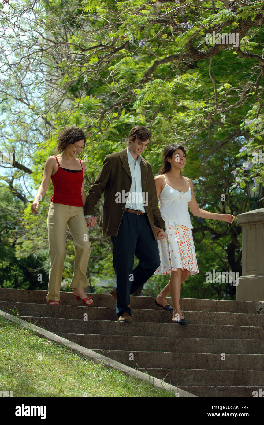 Three friends walking in a park Stock Photo - Alamy