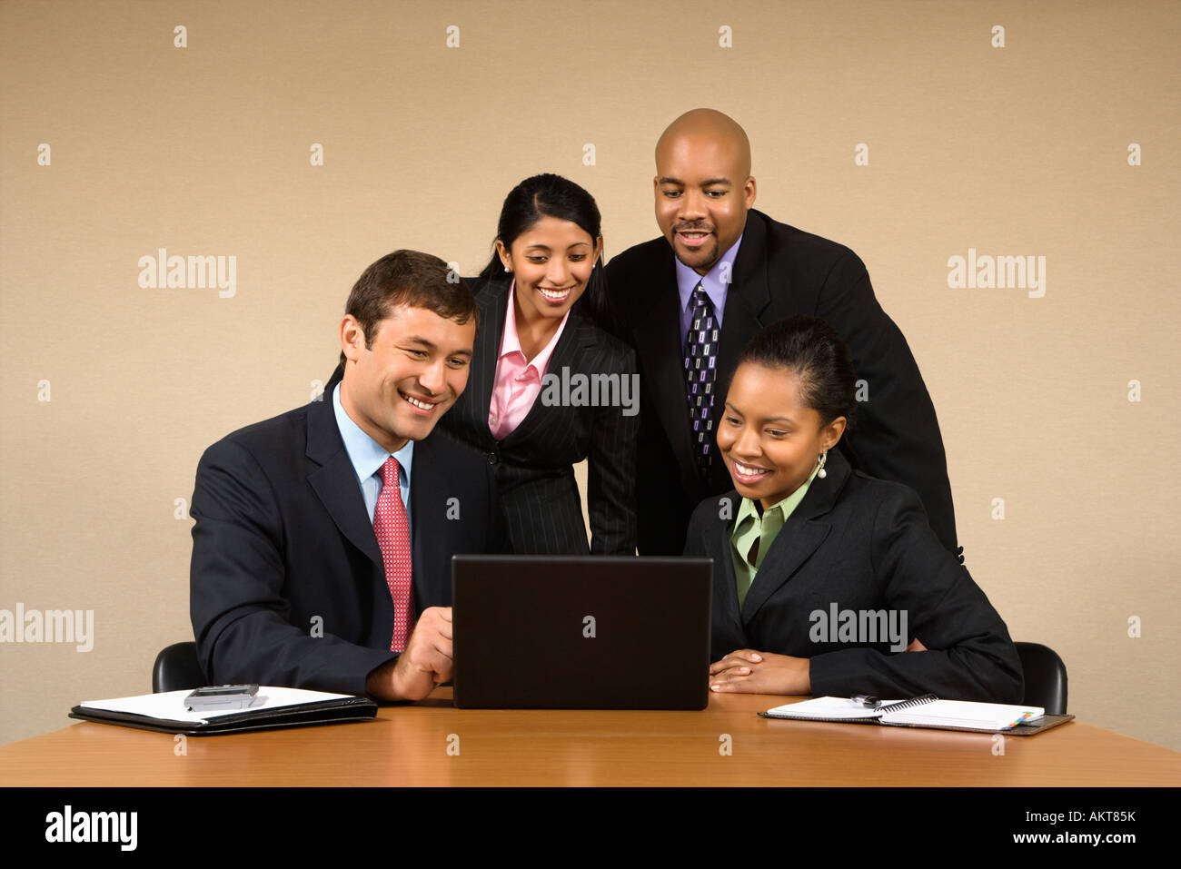 Team gathered around table sharing hi-res stock photography and images ...