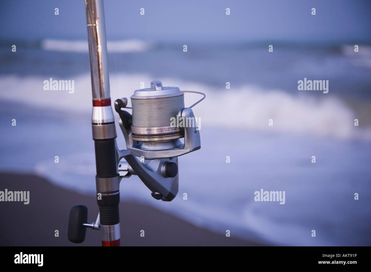Surf fishing rod on beach Stock Photo - Alamy