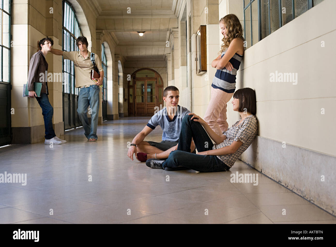 Teenagers in a college corridor Stock Photo - Alamy