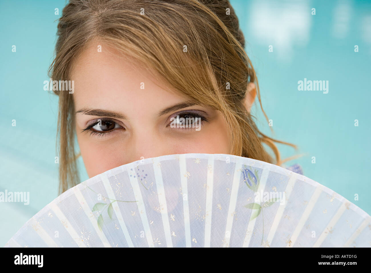 Young woman with fan Stock Photo - Alamy