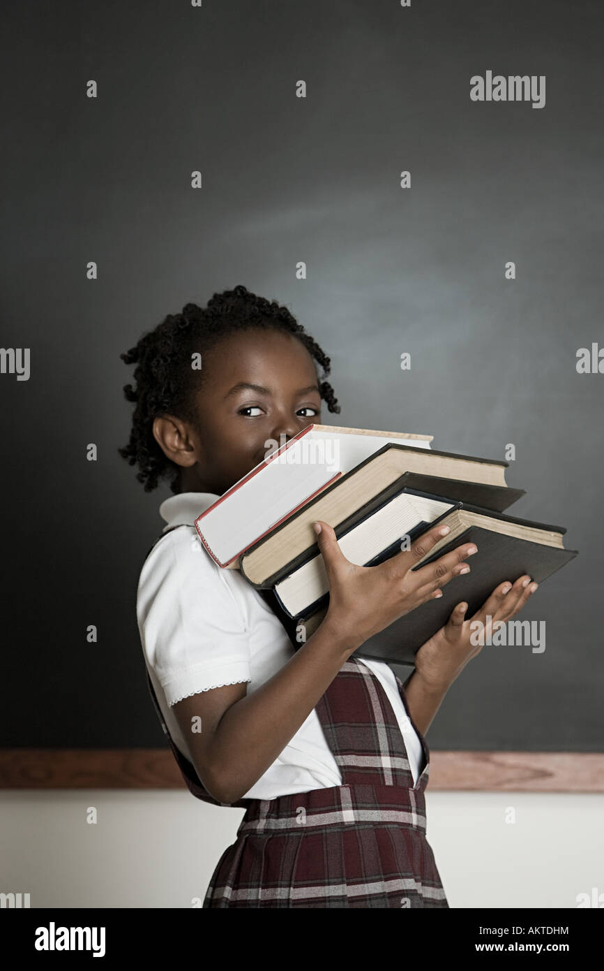 Girl holding books Stock Photo - Alamy
