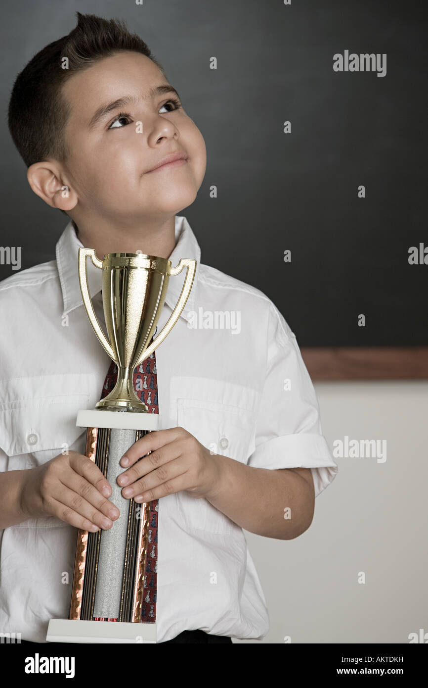 Boy holding a trophy Stock Photo - Alamy