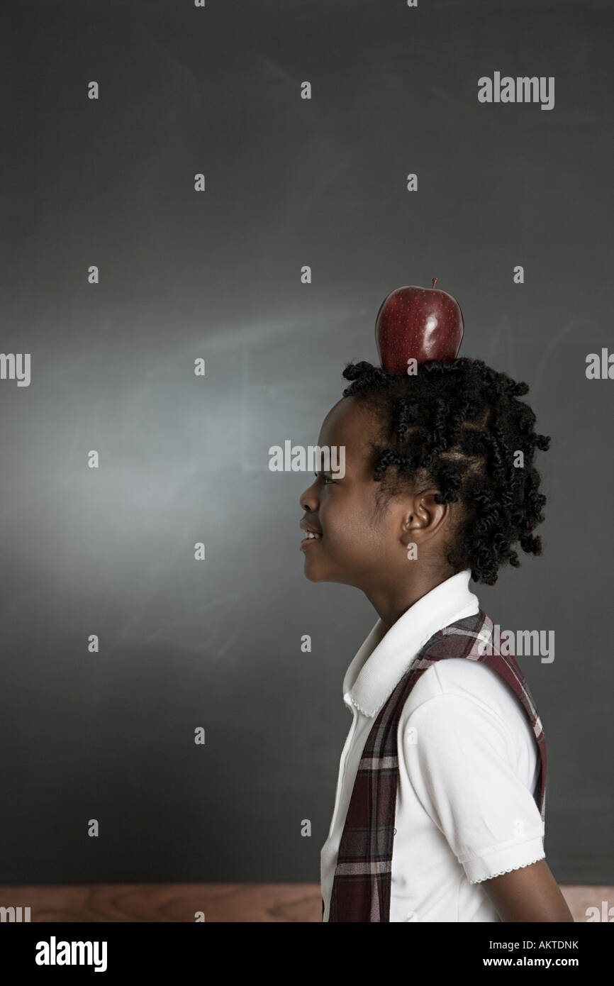 Schoolgirl balancing apple on head hi-res stock photography and images ...