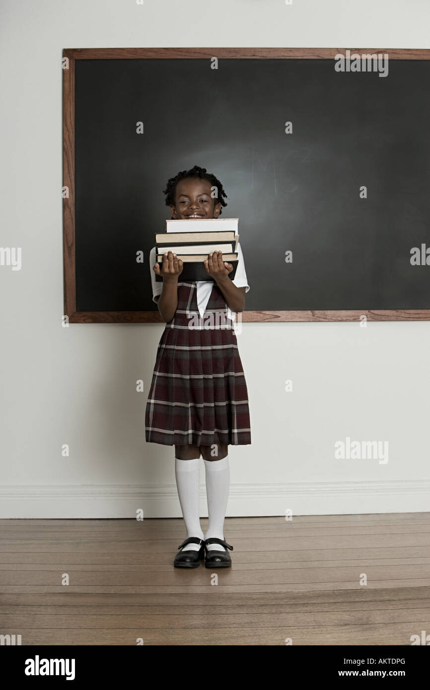 Girl holding books Stock Photo - Alamy