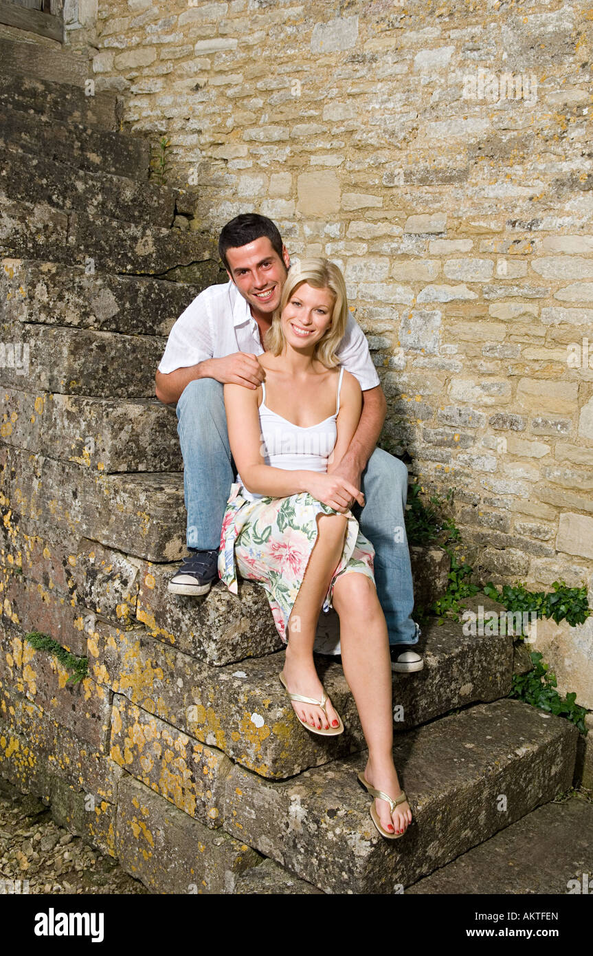 A couple sitting on steps Stock Photo - Alamy