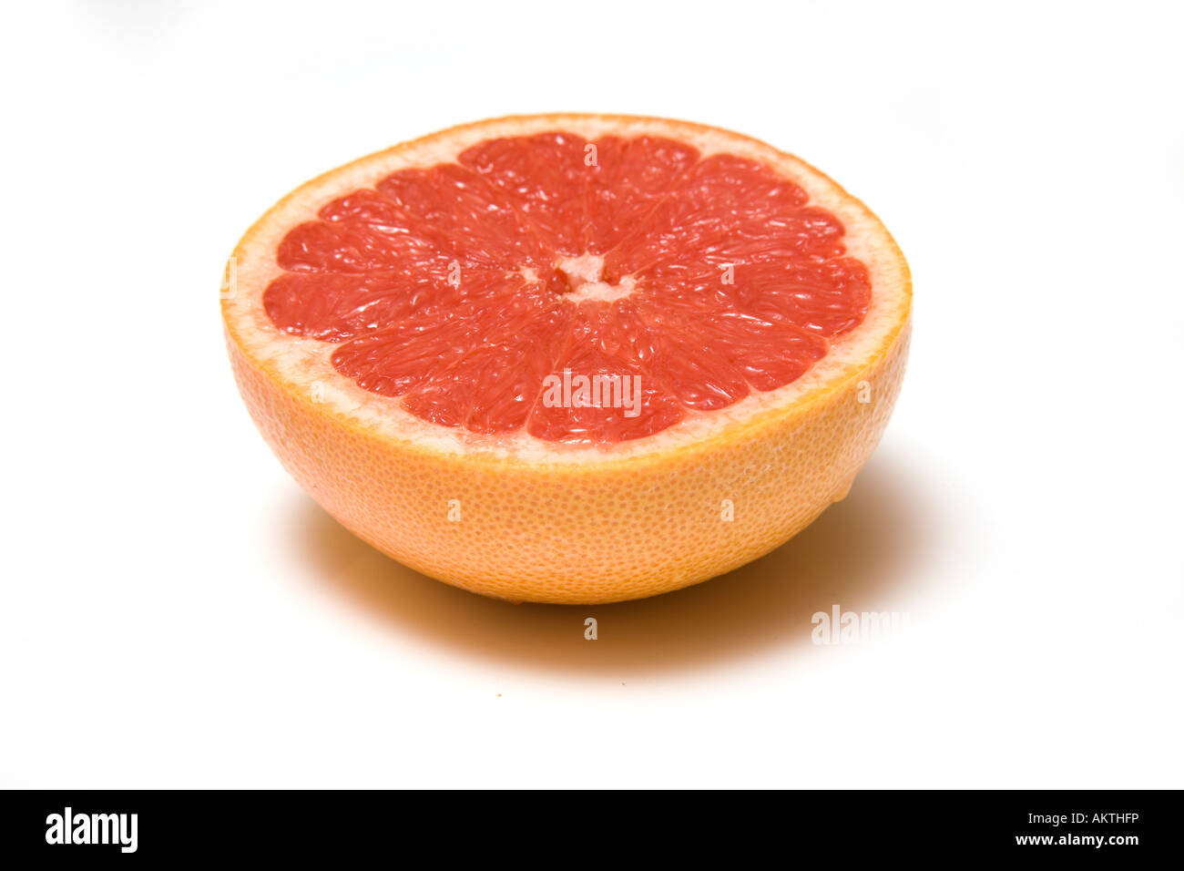 Grapefruit halved isolated on a white studio background Stock Photo - Alamy