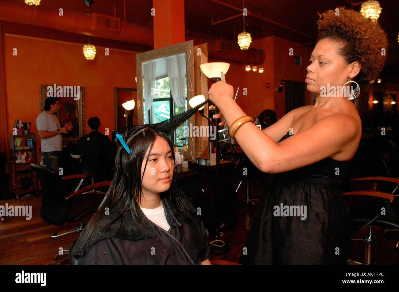 Haircutting and styling in a Soho NYC hair salon Stock Photo - Alamy