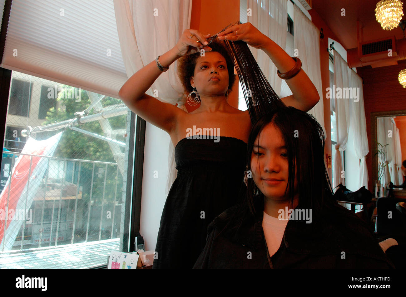 Haircutting and styling in a Soho NYC hair salon Stock Photo - Alamy