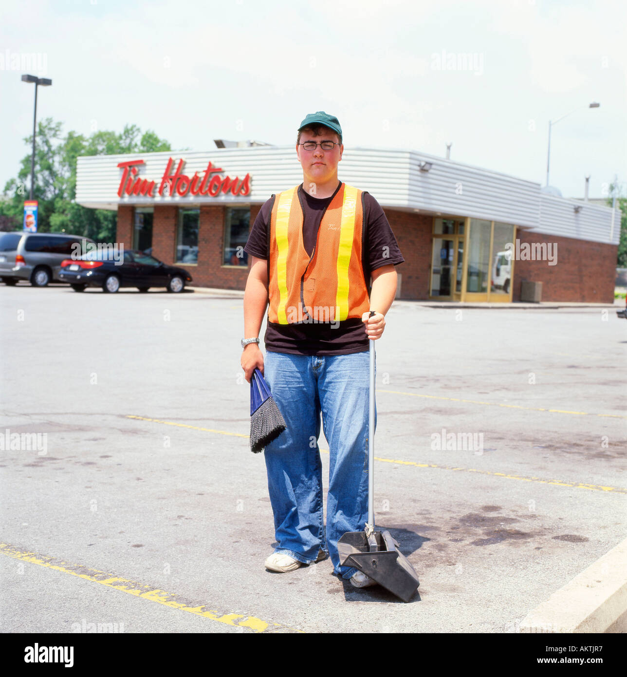 Young man employee student working at Tim Hortons fast food restaurant ...