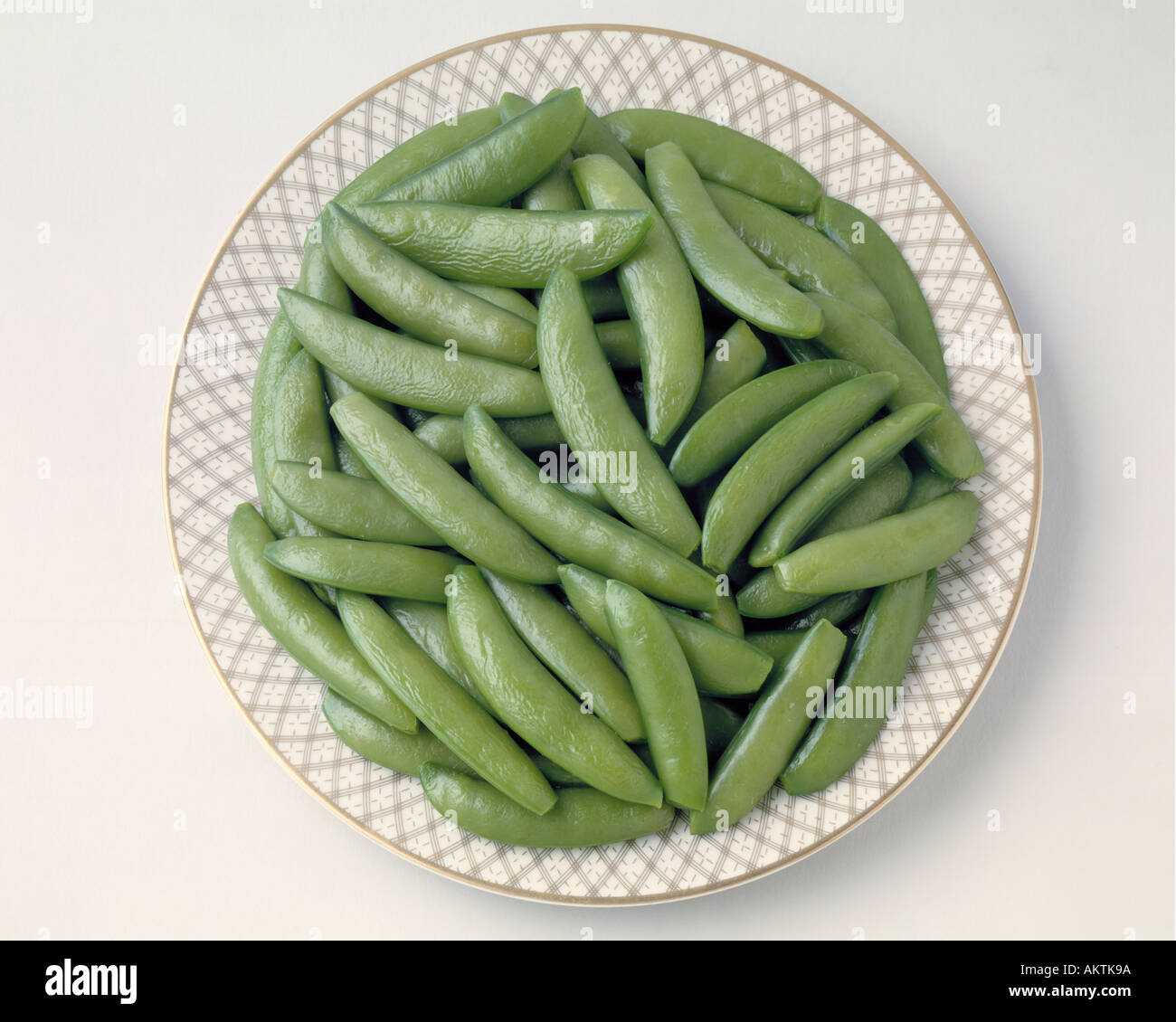 medley of green pea pods on gold rim plate frozen vegetables Bon ...