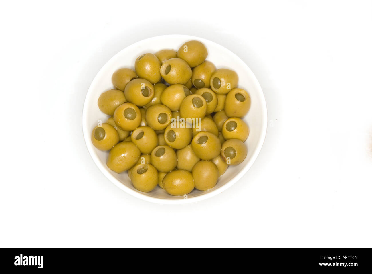 A bowl of stuffed olives isolated on a white studio background Stock ...
