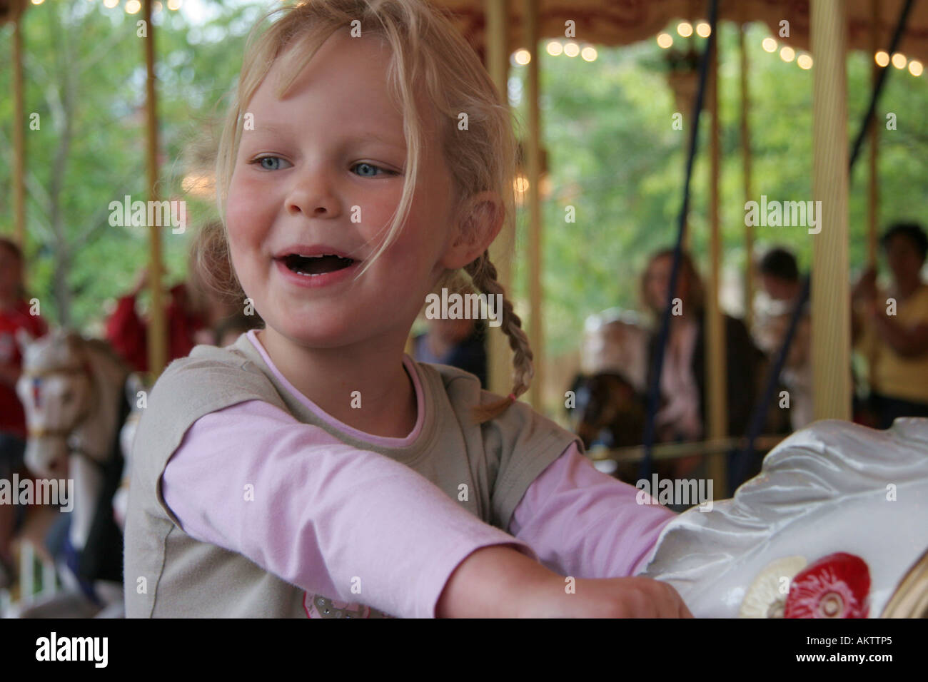 young girl enjoying carousel ride Stock Photo - Alamy